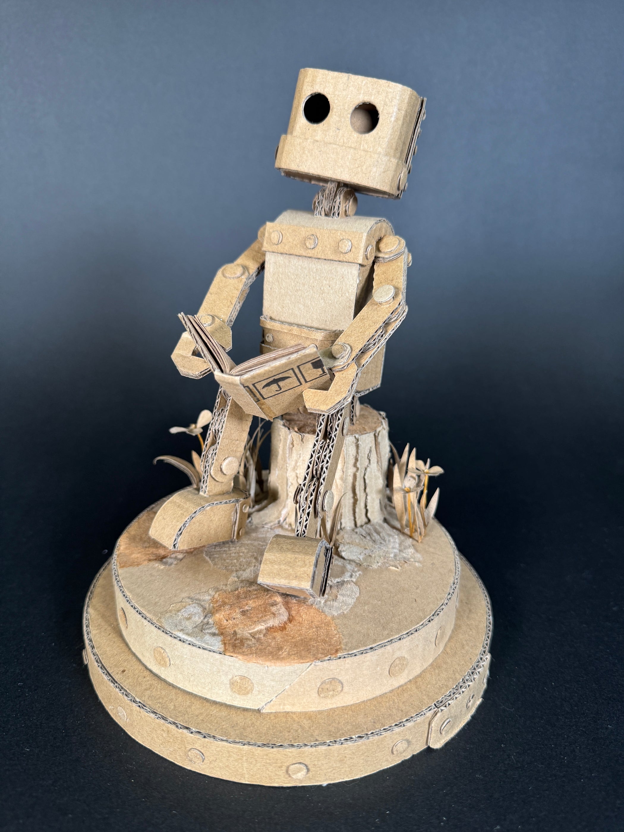 Paper Robot (Reading on stump) — The Compound Gallery